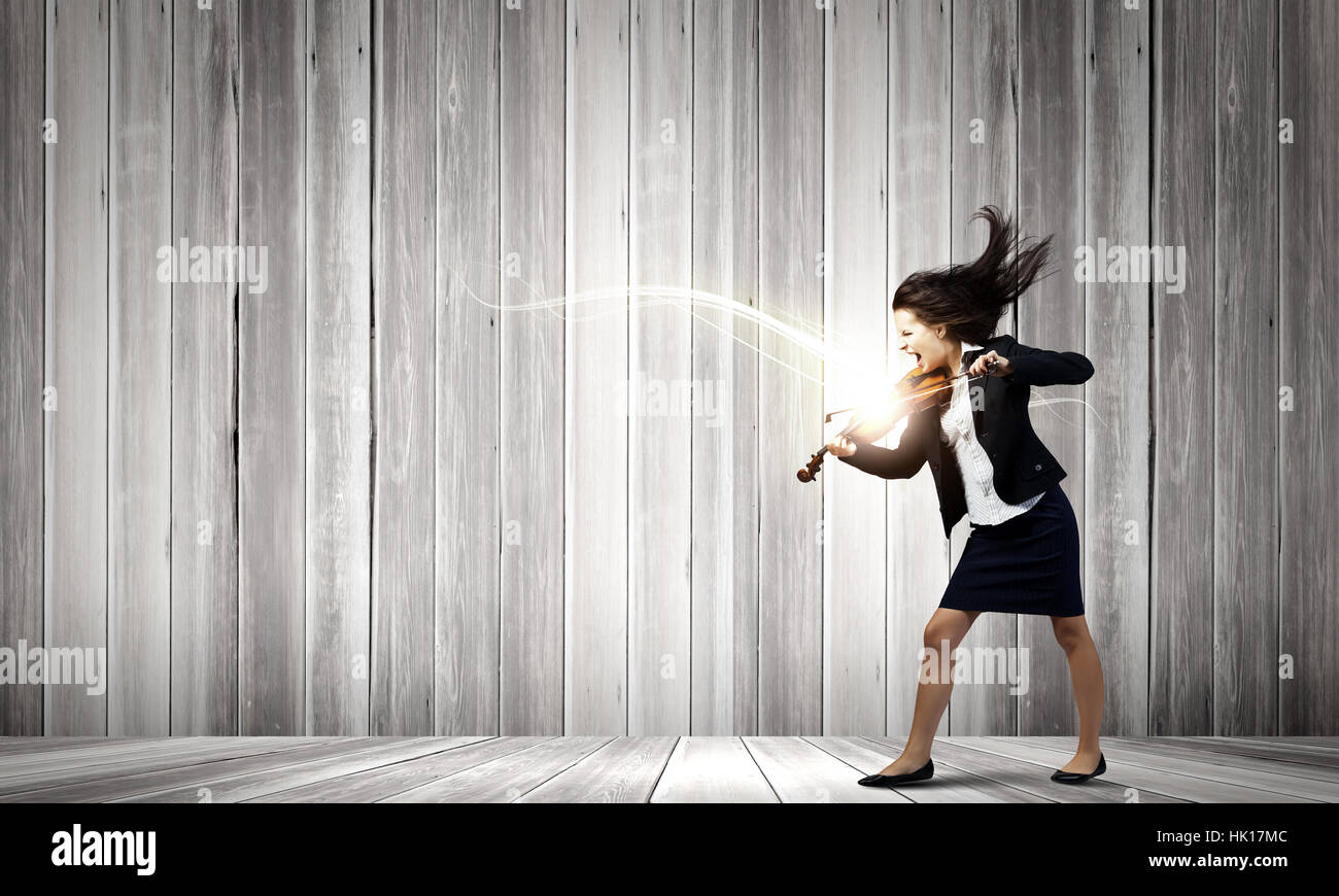 Young determined woman in black suit playing violin hi-res stock ...
