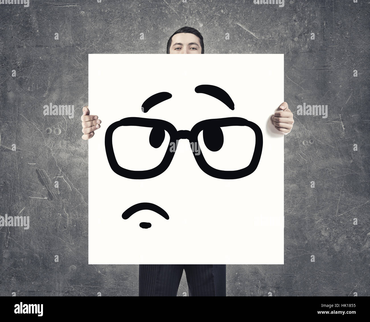 Businessman hold white board with sad face emoticon hi-res stock ...