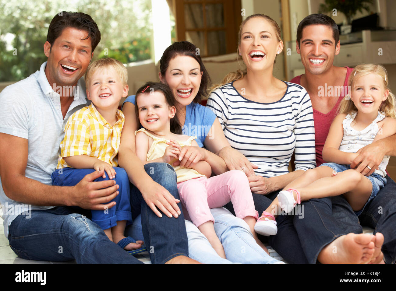 Two Families Sitting Outside House Stock Photo - Alamy