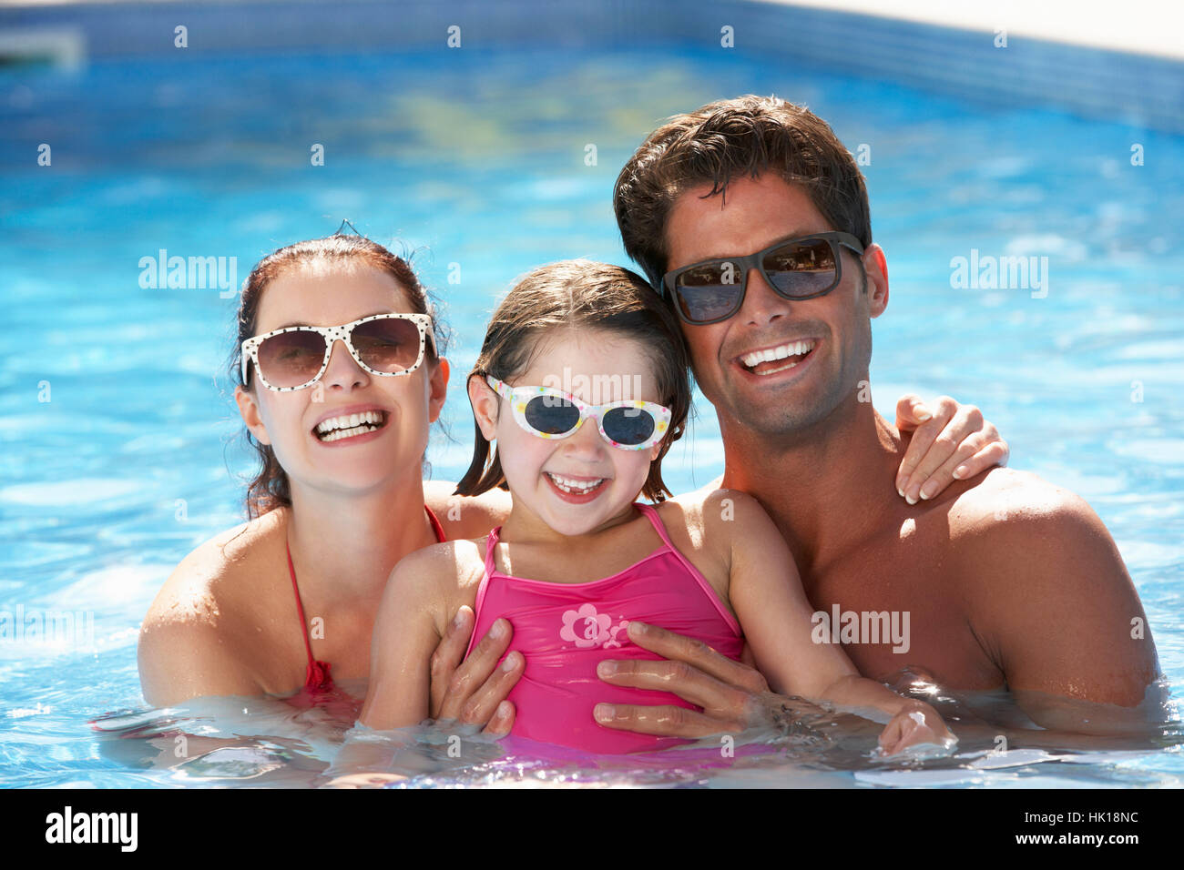Family Having Fun In Swimming Pool Stock Photo - Alamy