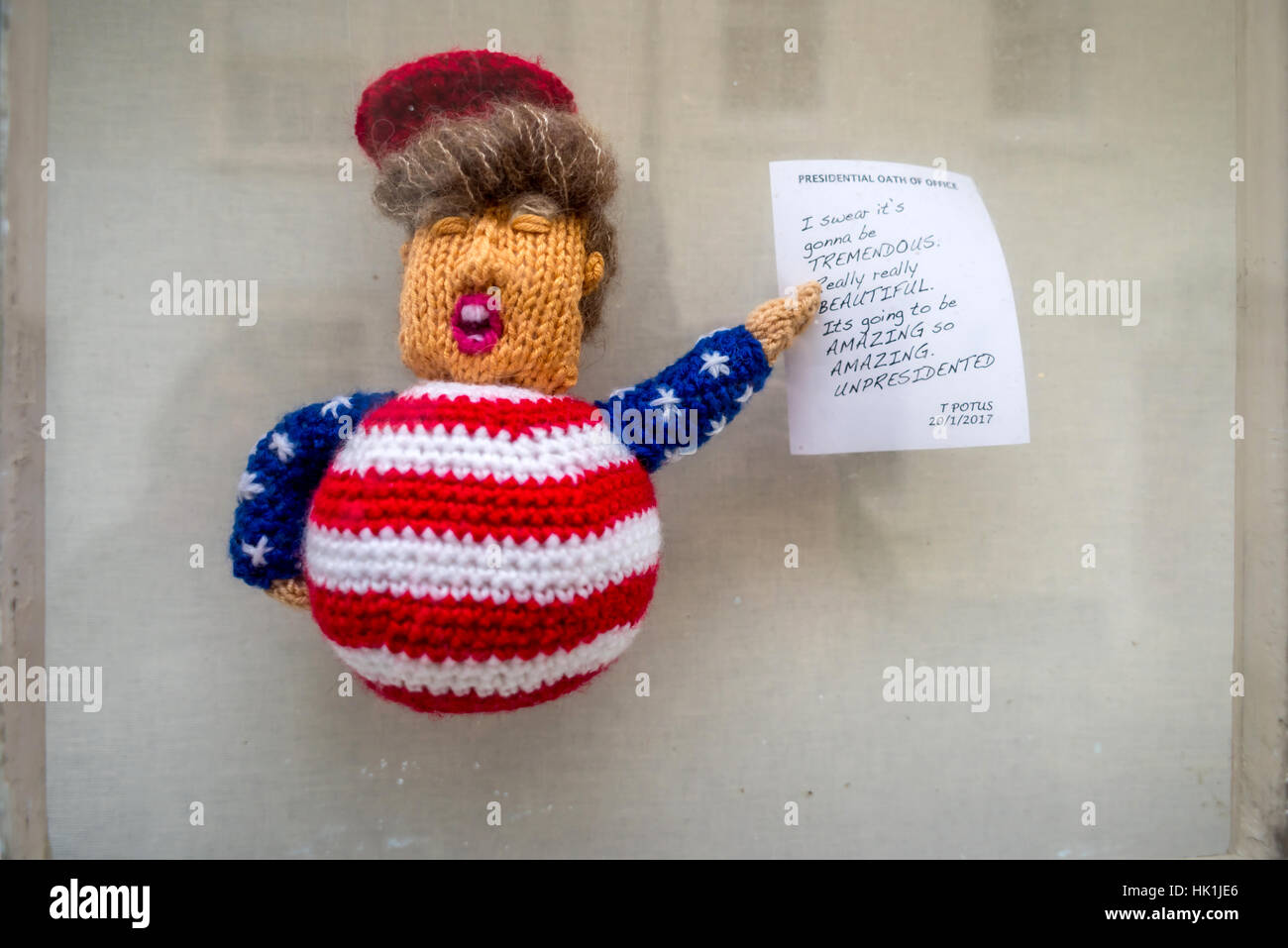 A knitted version of President Donald Trump hanging in a house window ...