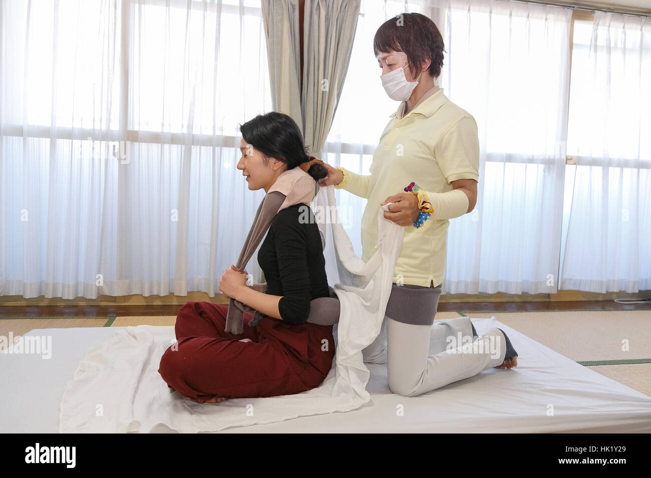 Tokyo, Japan. 4th Feb, 2017. A therapist wraps a woman in cloth during ...