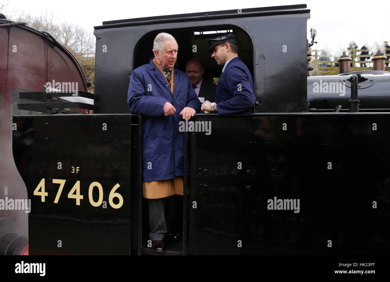 The Prince of Wales looks down from the foot plate of a steam ...