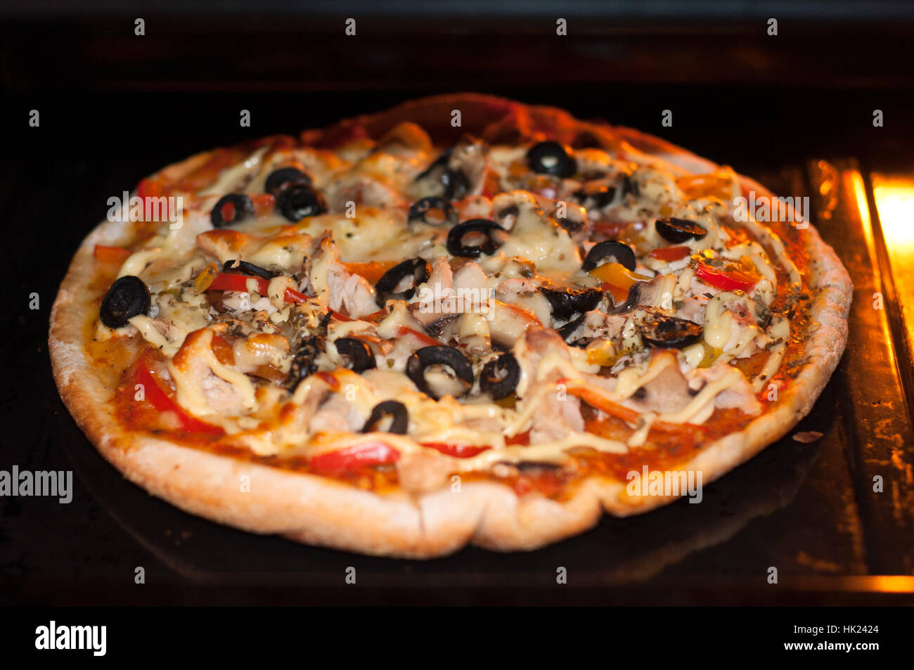 Homemade pizza in oven Stock Photo - Alamy