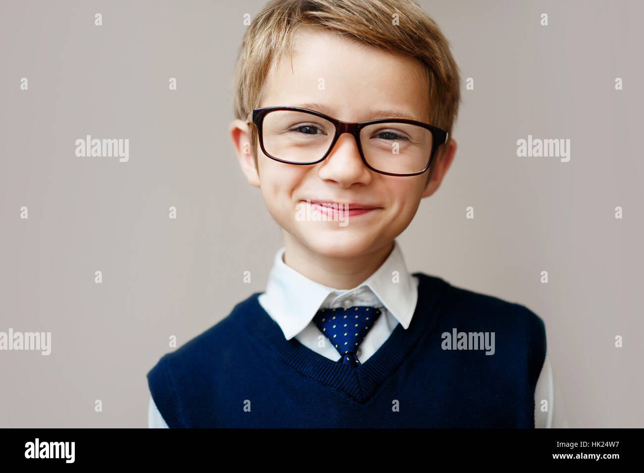 Closeup of little boy in school uniform. Happy schoolboy smiling and ...