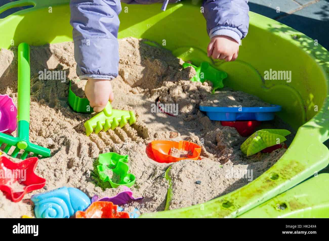 Child playing in sandbox Stock Photo - Alamy