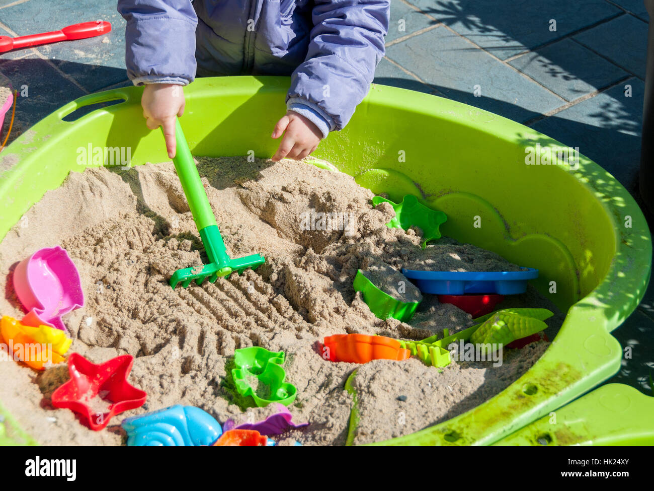 Child playing in sandbox Stock Photo - Alamy
