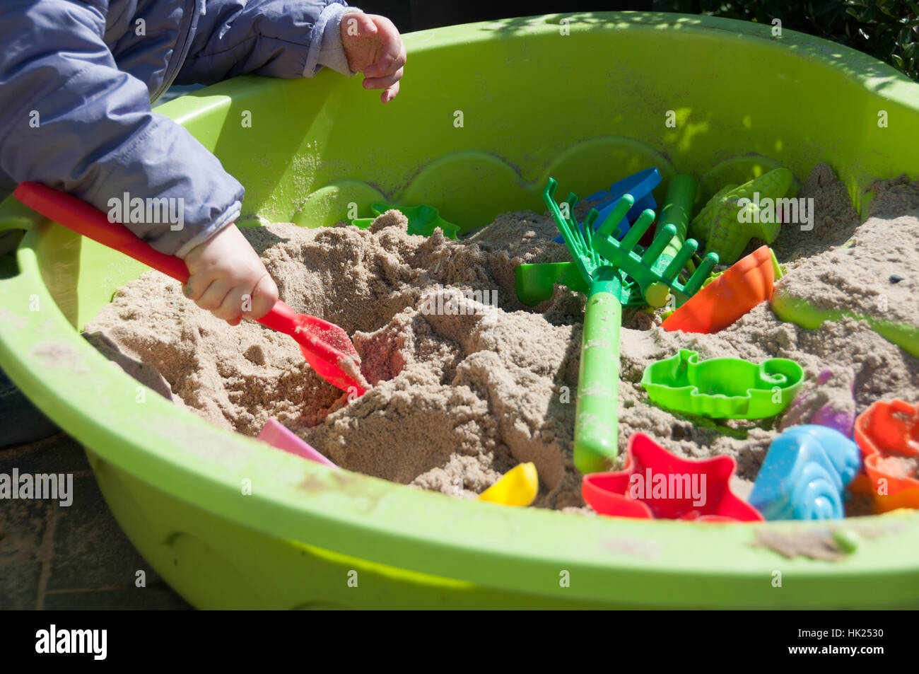 Child playing in sandbox Stock Photo - Alamy