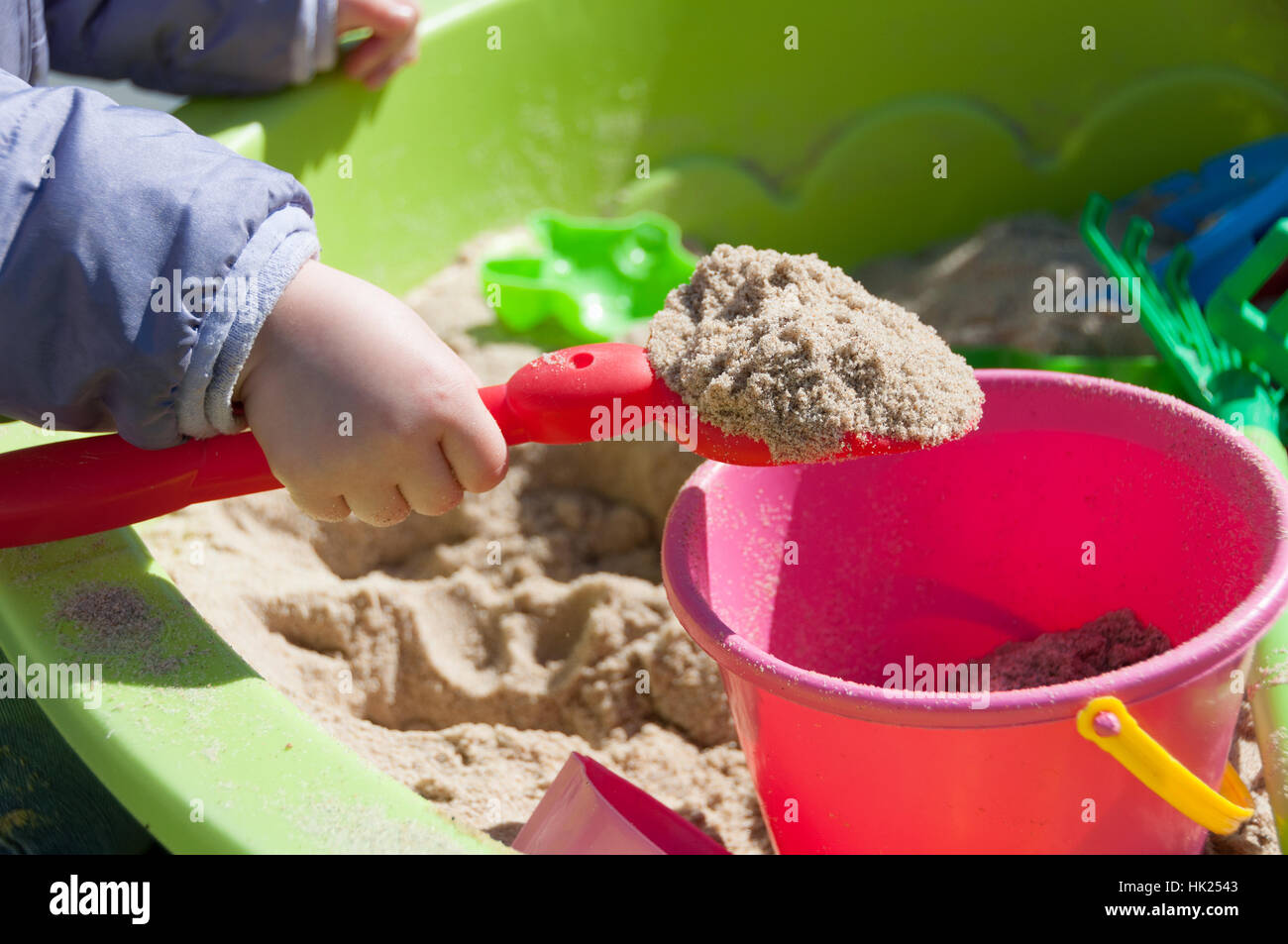 Child playing in sandbox Stock Photo - Alamy