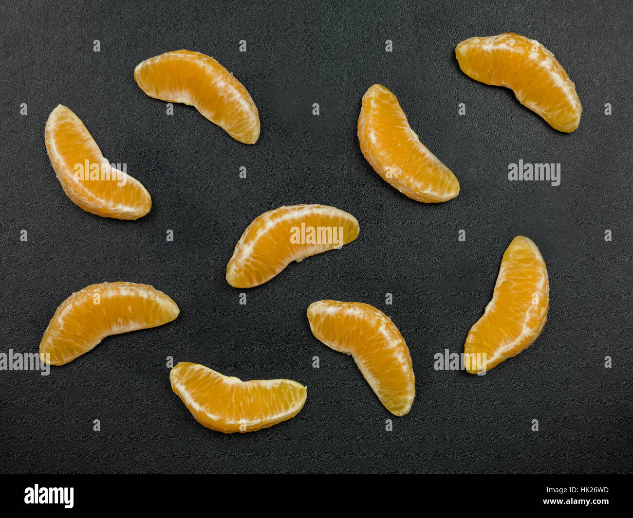 Fresh Fruit Orange Segments on a Black Background Stock Photo - Alamy