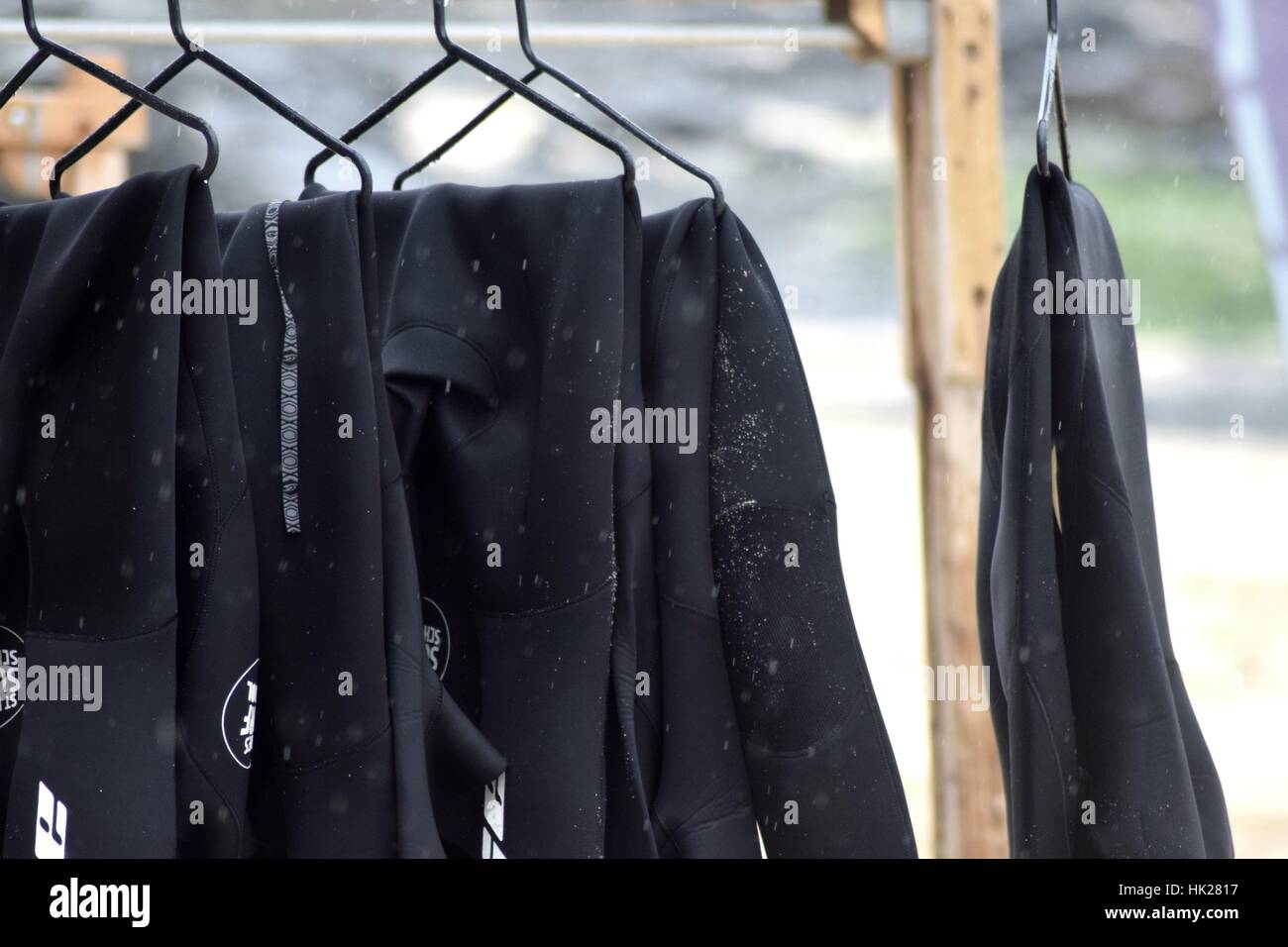 Wetsuits hanging up to dry at a beach in St Ives Stock Photo - Alamy