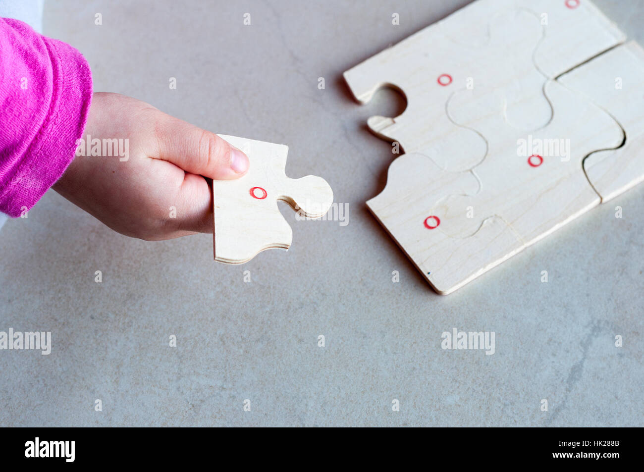 Little child solving a puzzle Stock Photo - Alamy