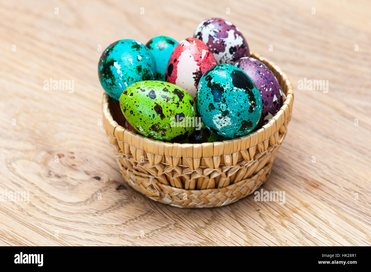 Coloured Easter eggs in a basket Stock Photo - Alamy