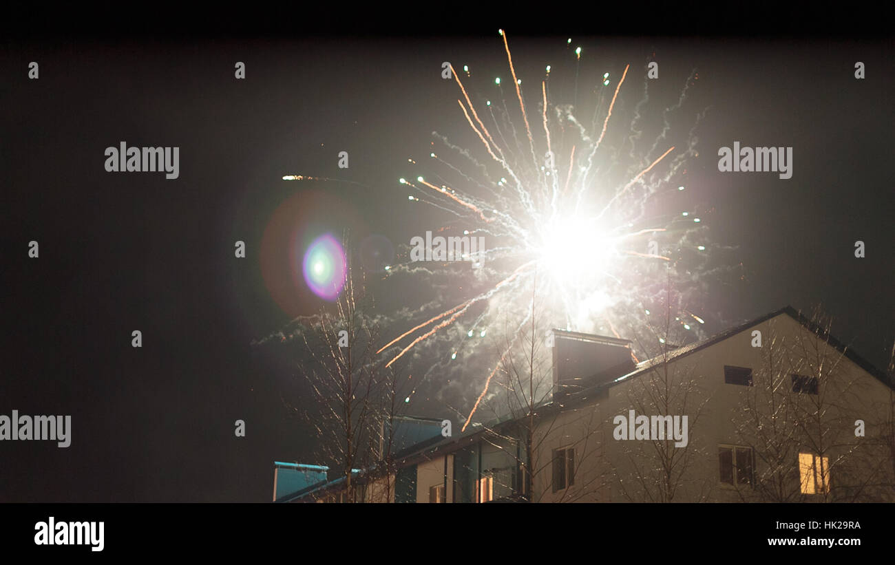 fireworks in the night sky over houses Stock Photo - Alamy