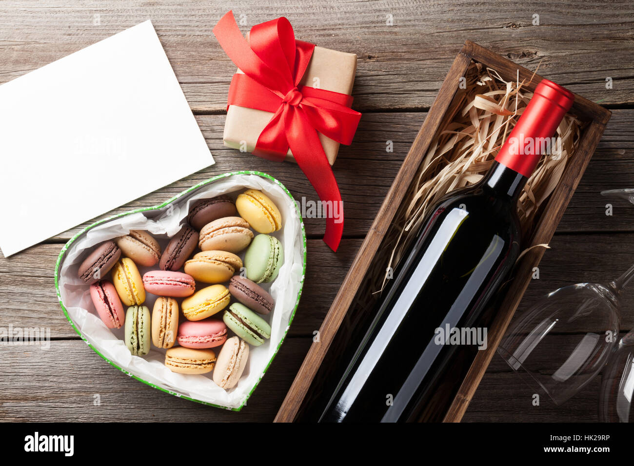 Valentines day greeting card. Red wine, macaroons gift box and glasses ...