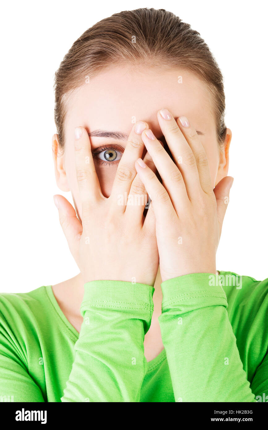 shy or scared teenage girl peeking through covered face Stock Photo - Alamy