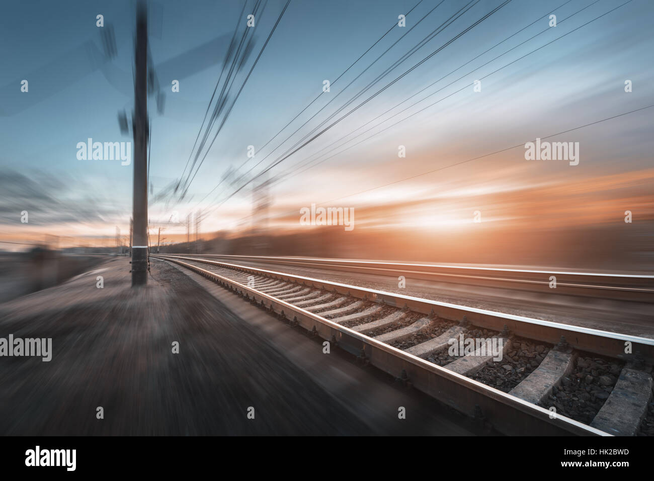 Railroad in motion at sunset. Railway station with motion blur effect ...
