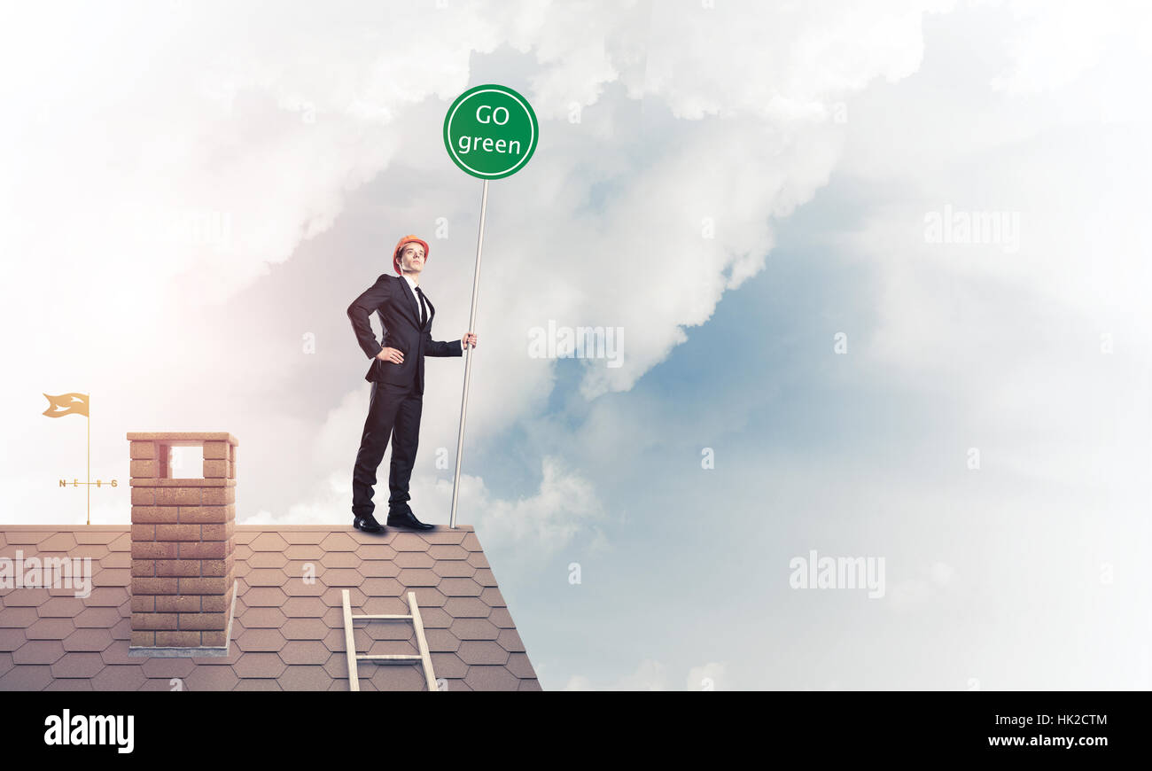 Businessman in suit on house top with ecology concept signboard Stock ...