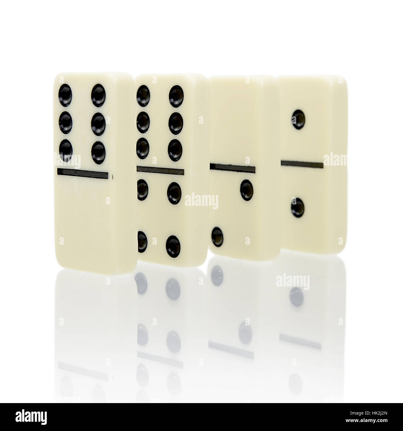 Four dominoes stand on a white background Stock Photo - Alamy