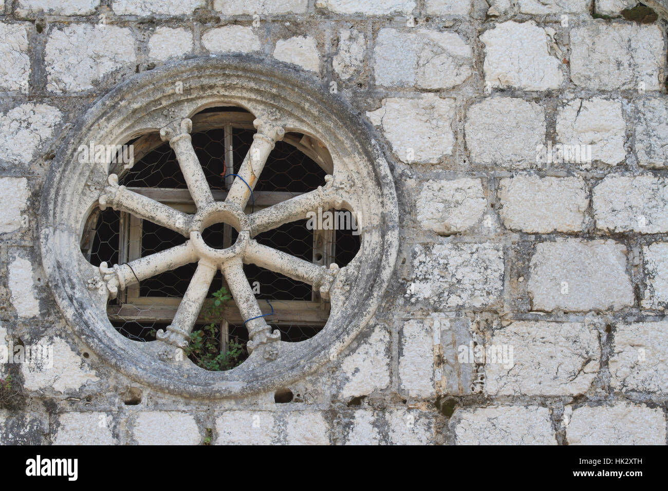 Round window in an old stone wall close-up Stock Photo - Alamy