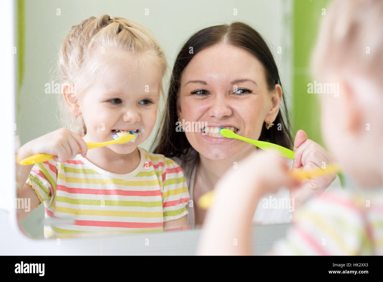 Mother And Child Daughter Brushing Teeth Together Stock Photo - Alamy