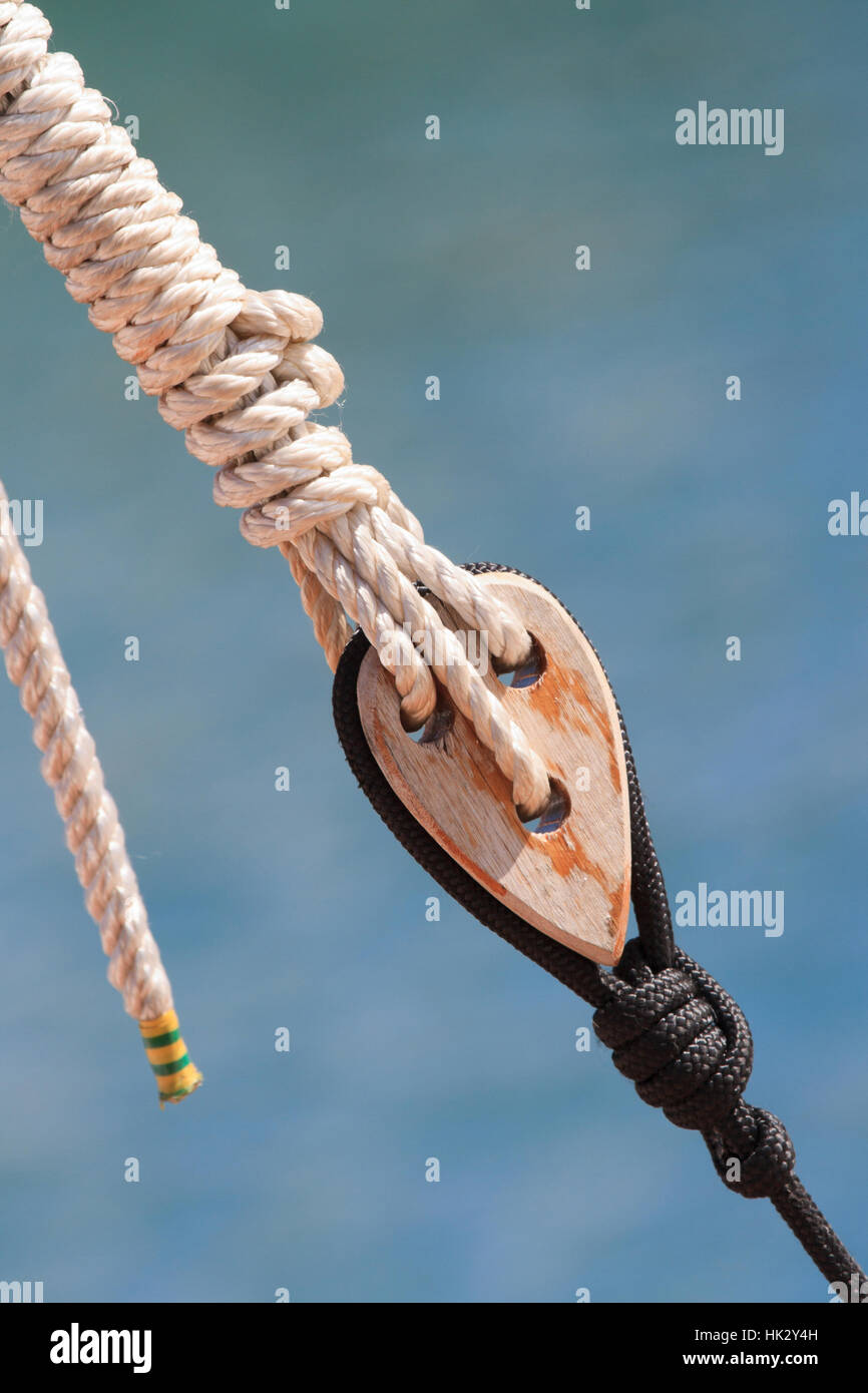 Ancient marine pulleys with rope closeup, vertical Stock Photo - Alamy