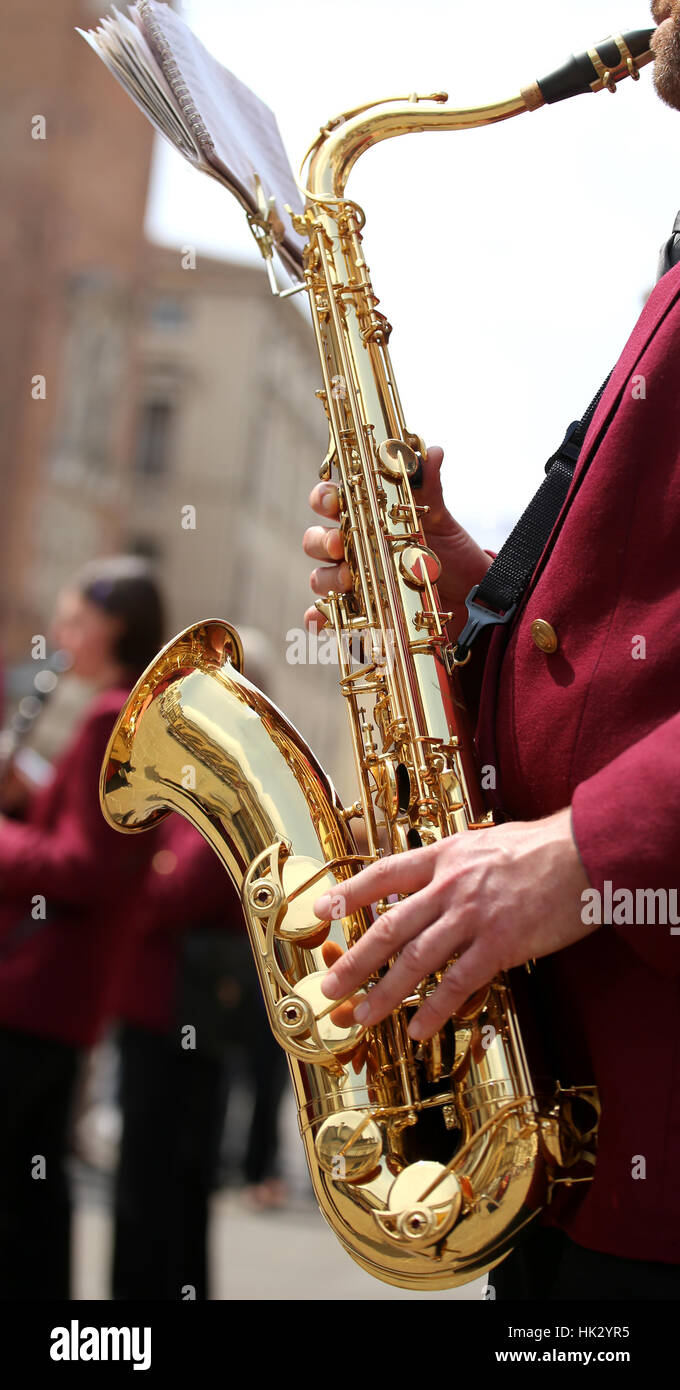 hand of player and the golden saxophone in the main square of european ...