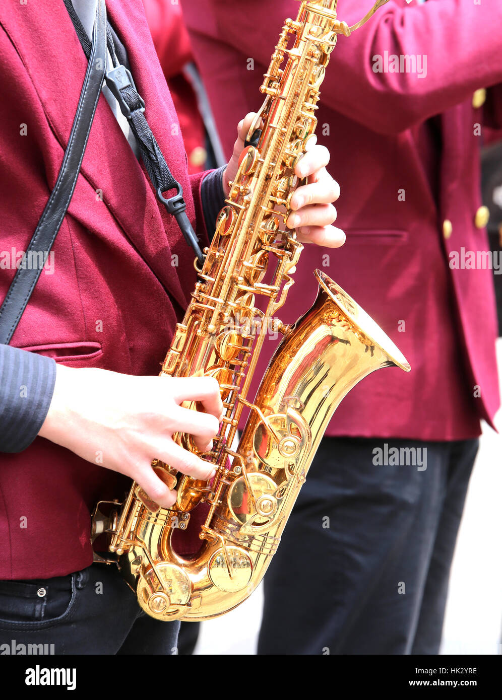 young player plays the saxophone in the brass bas outside Stock Photo ...
