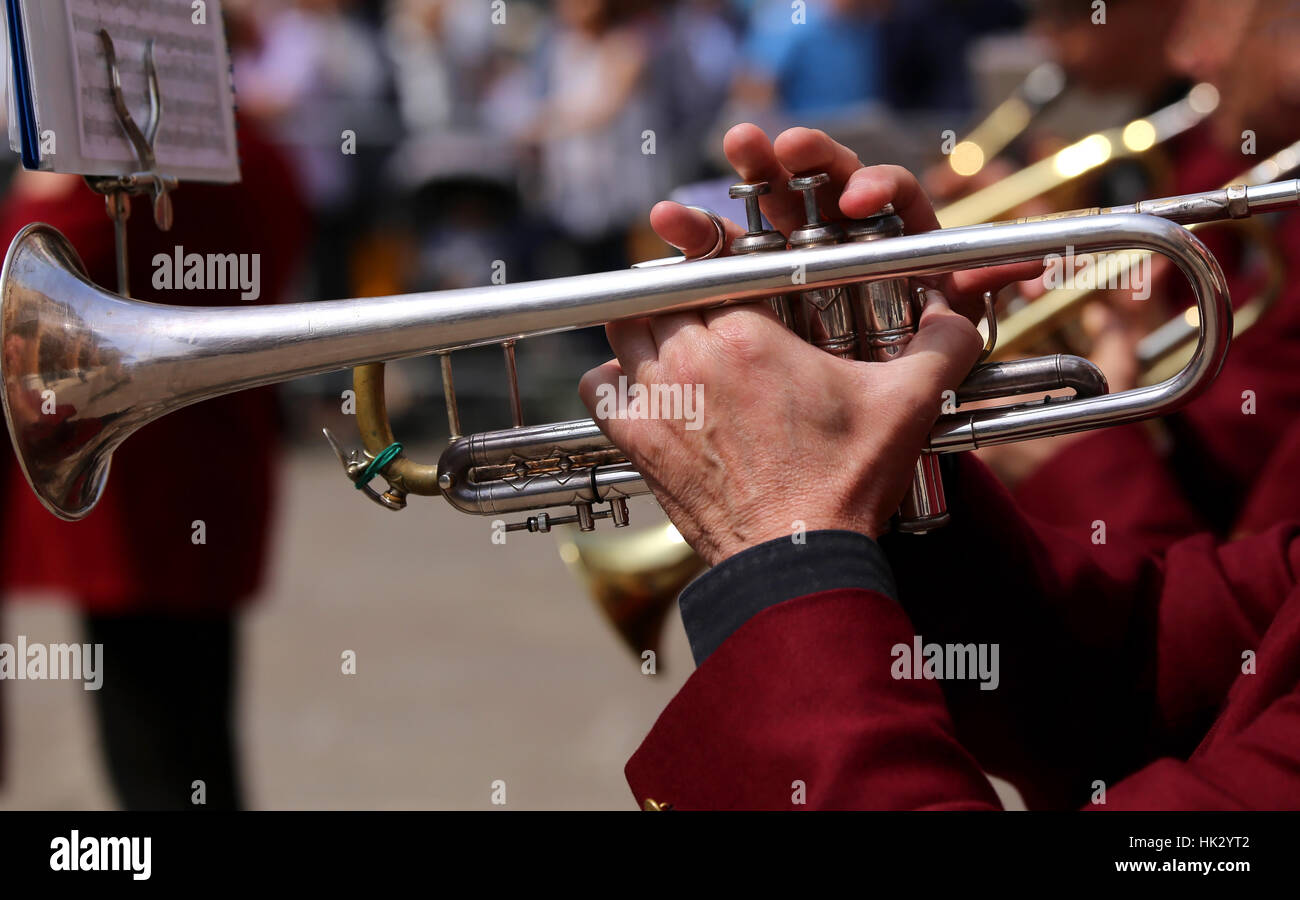 trumpet player plays during an outdoor live performance of a brass band ...