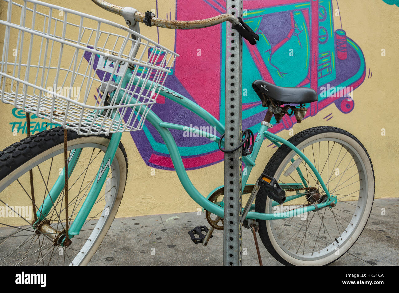 Picture of part of a turquoise-colored bicycle chained to a post in ...