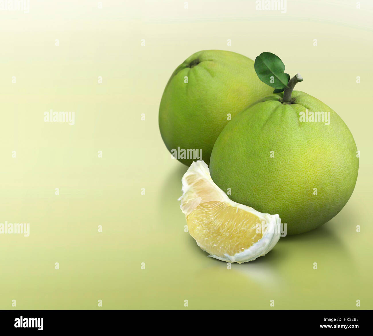 Pomelo on green solid background Stock Photo - Alamy