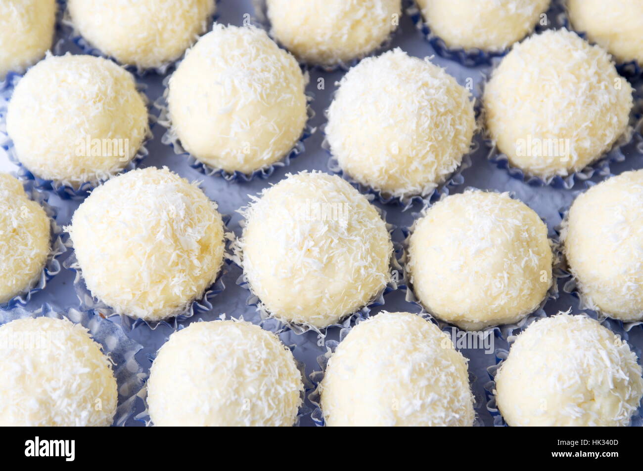 Coconut round homemade cookie balls in paper holders Stock Photo - Alamy