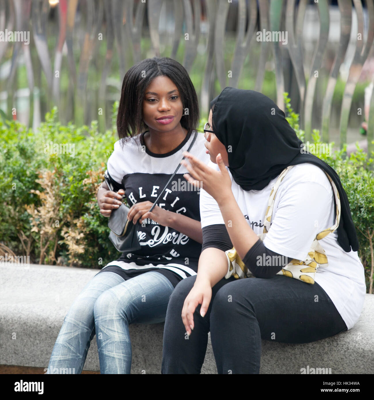 Two children talking multiethnic hi-res stock photography and images ...