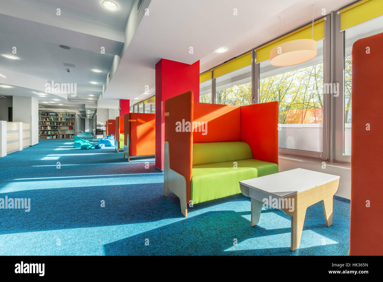 Library lounge area with green sofas and red partitions Stock Photo - Alamy