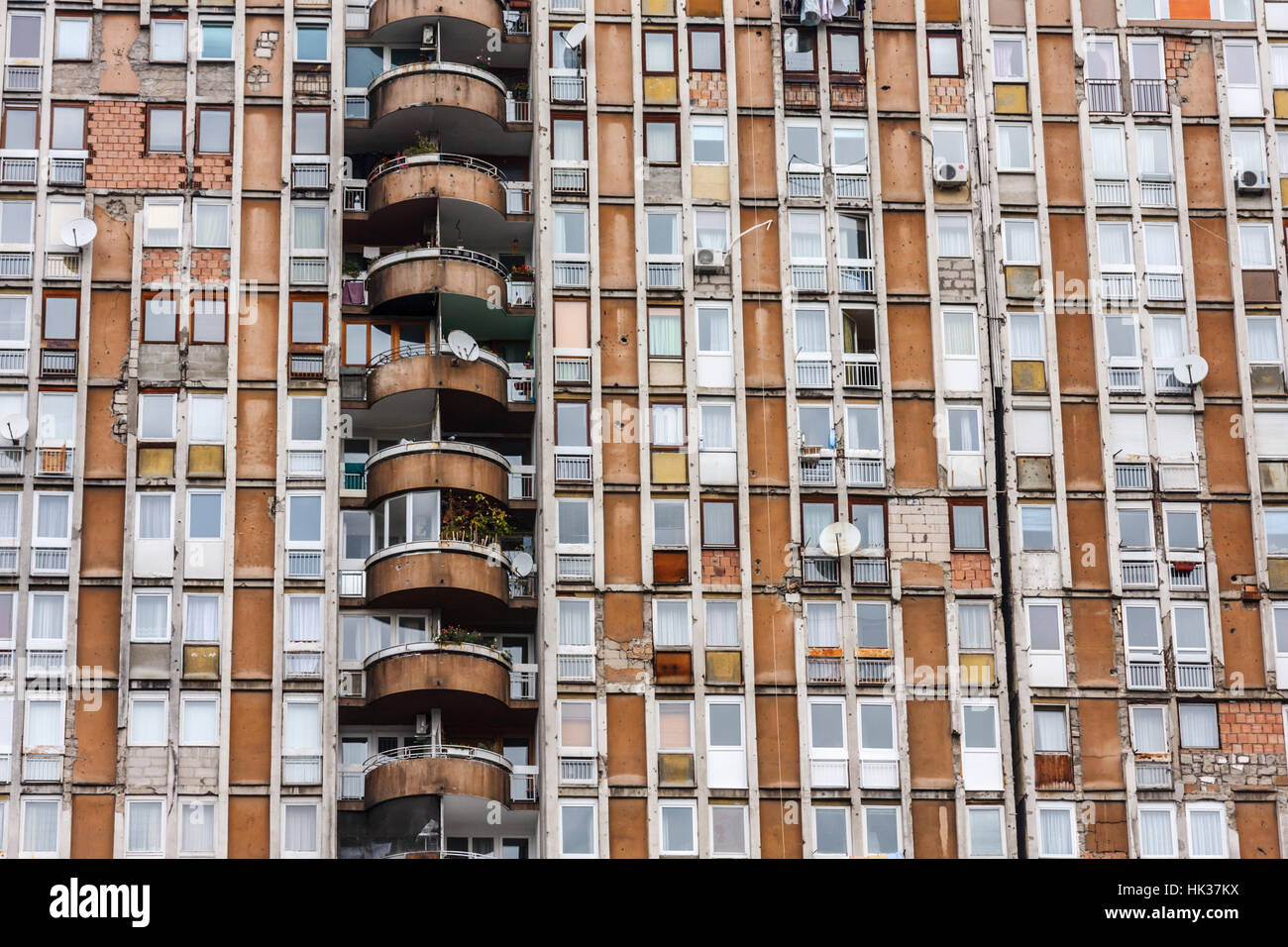 Tall apartment building showing signs of damage of the Yugoslavian Wars ...