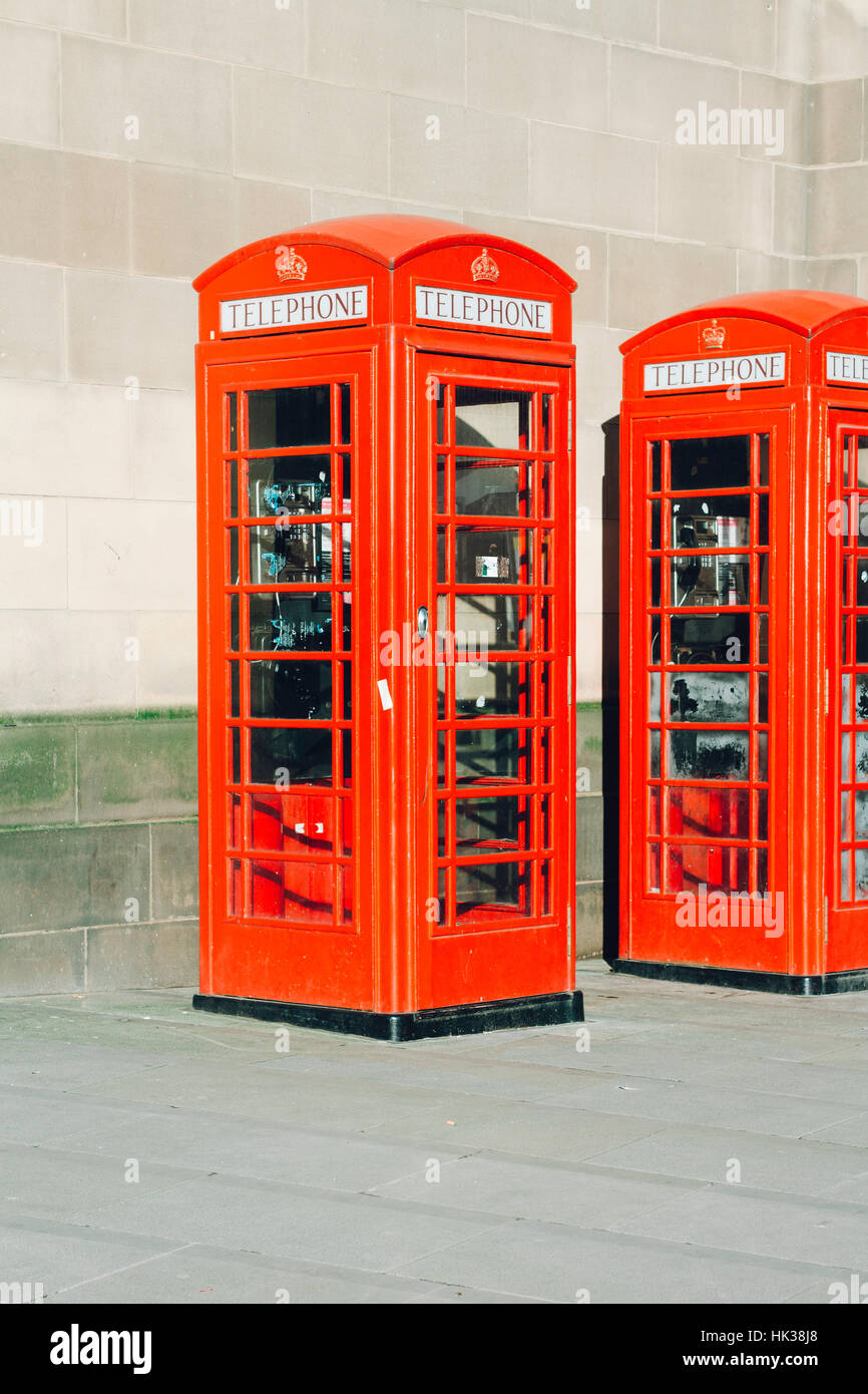 Red British telephone booths in the sun Stock Photo - Alamy