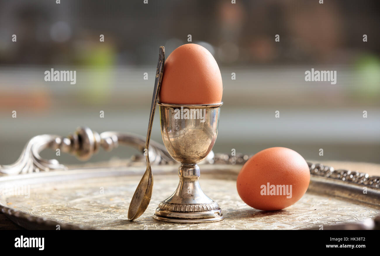 Eggs and a silver egg cup in an old tray Stock Photo - Alamy