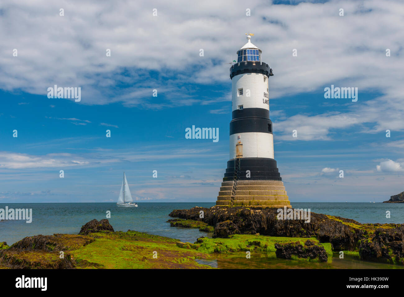Trwyn Du lighthouse at Penmon with yacht and Puffin island in ...