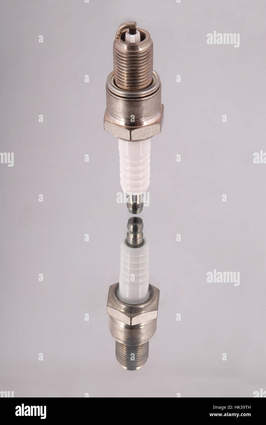 One new spark plugs on a mirror background Stock Photo - Alamy