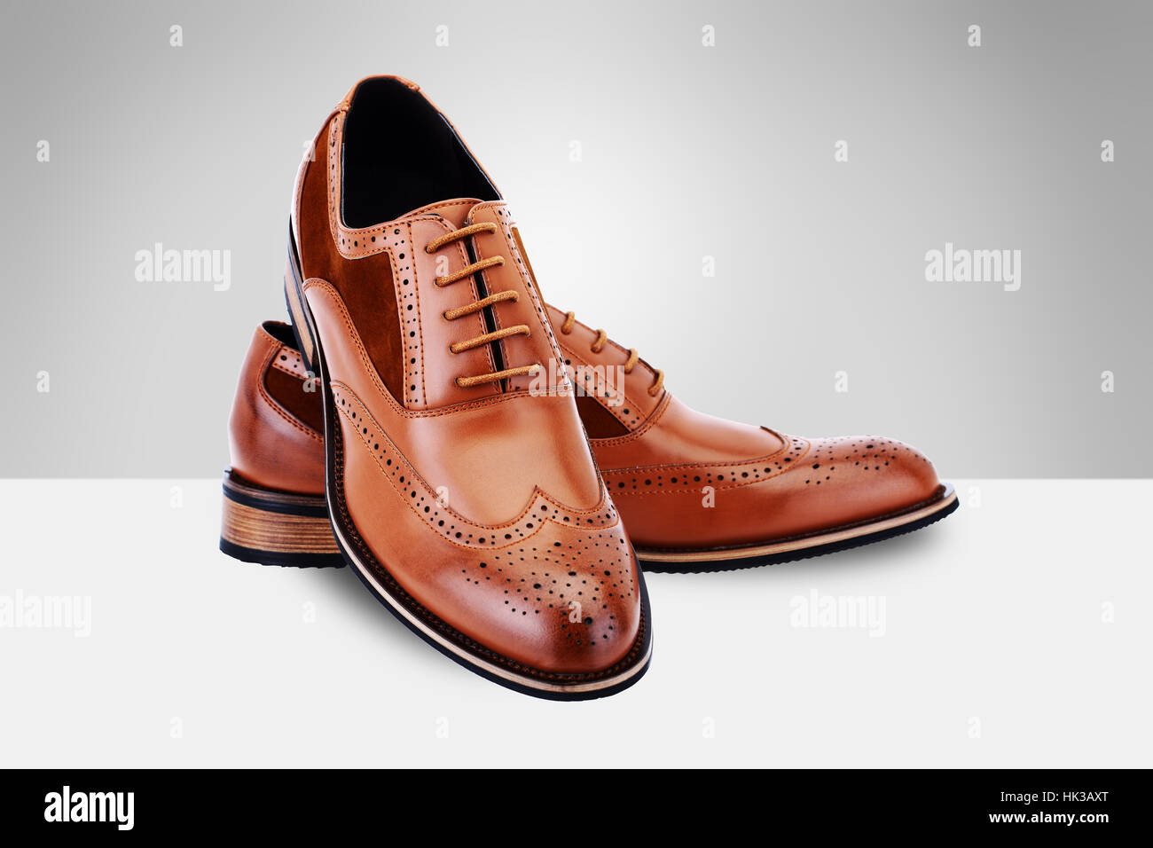 Brown men's shoes on split background Stock Photo - Alamy