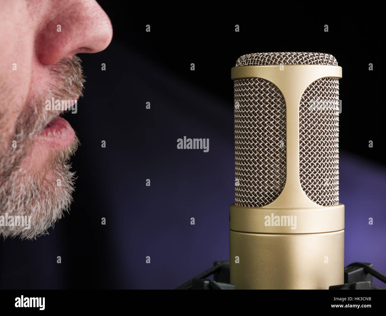 golden broadcast voice microphone on dark background - closeup shot ...