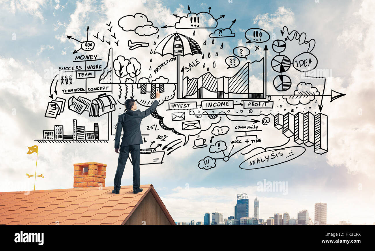 Rear view of businessman on house roof drawing his new business Stock ...