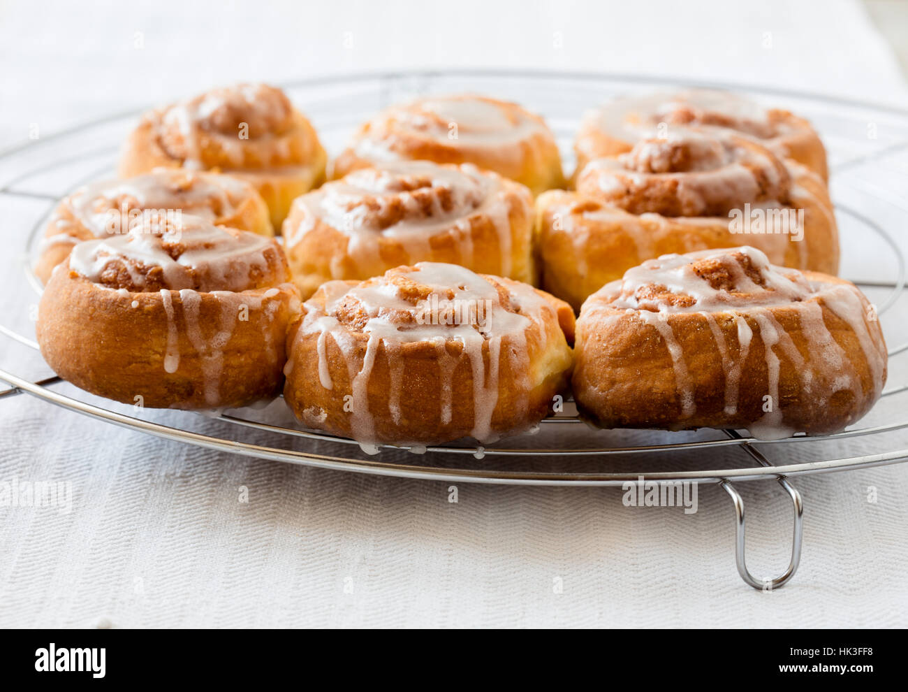 Delicious cinnamon buns with glaze icing Stock Photo - Alamy