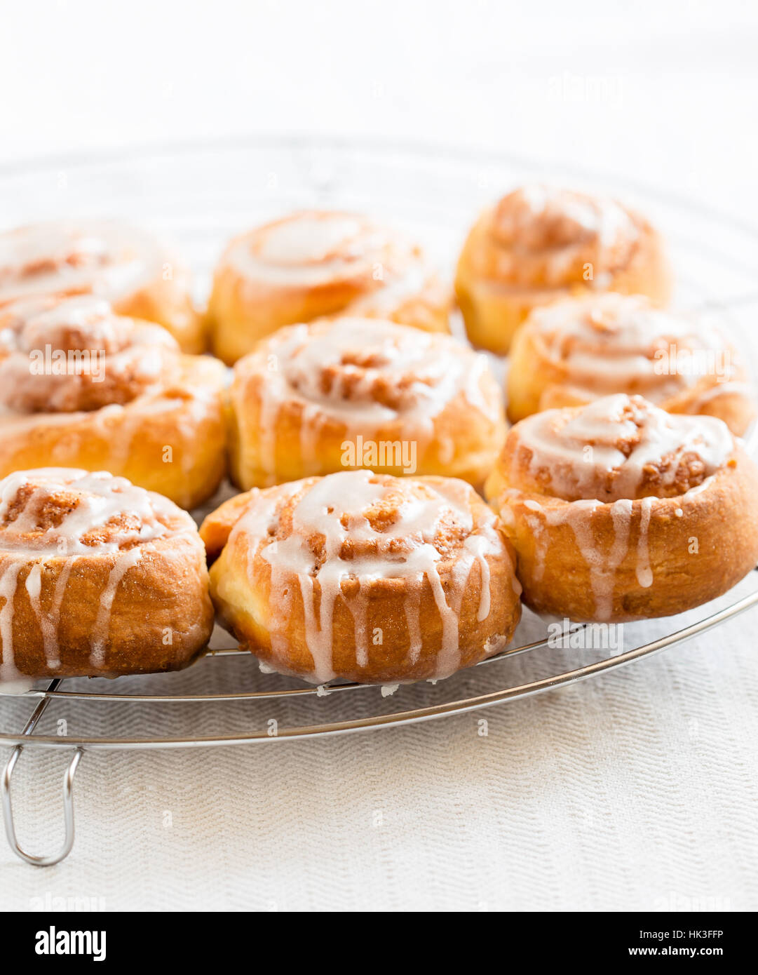 Delicious cinnamon buns with glaze icing Stock Photo - Alamy