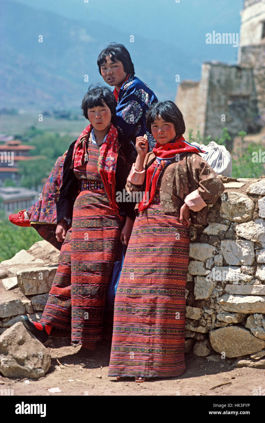 Bhutanese girls in traditional costumes at at the Paro Tshechu, mask ...