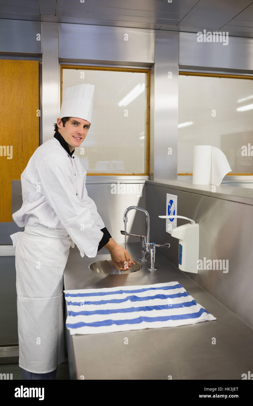 Smiling chef washing hands in the restaurant Stock Photo - Alamy