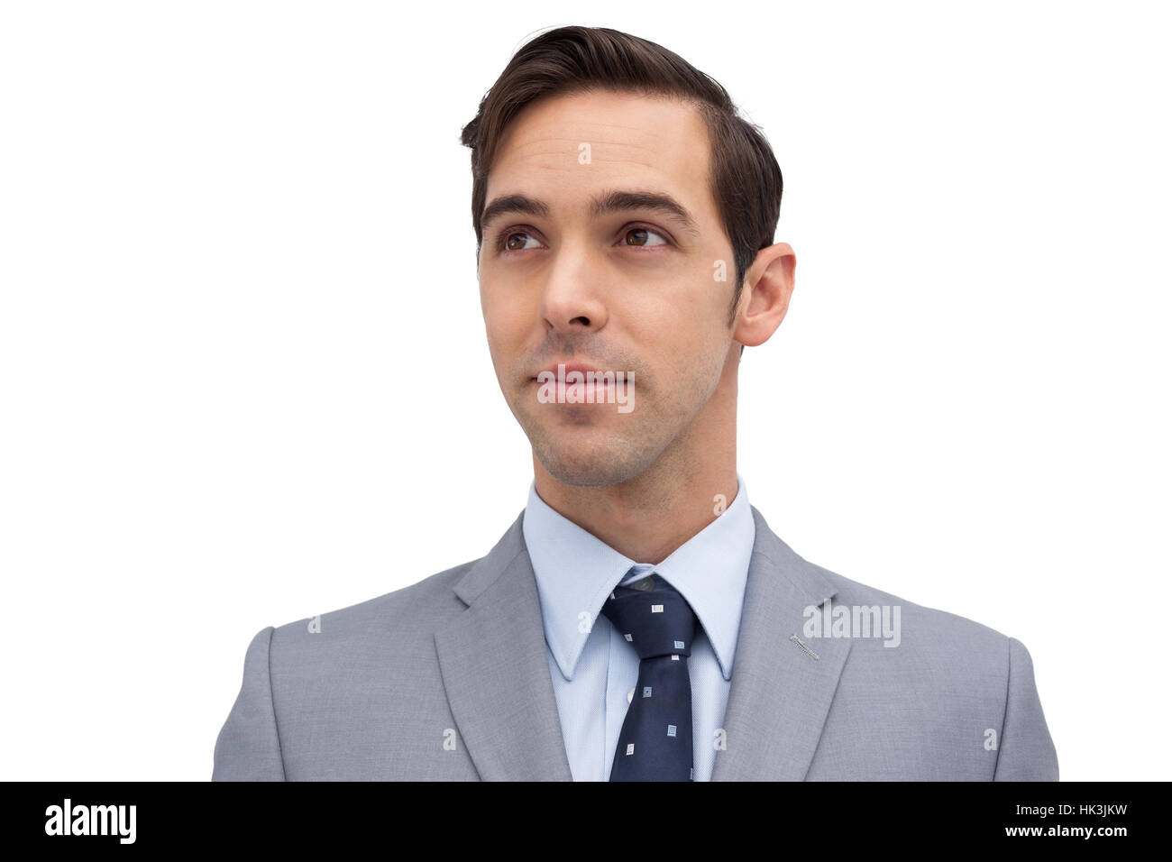 Young businessman looking away against white background Stock Photo - Alamy