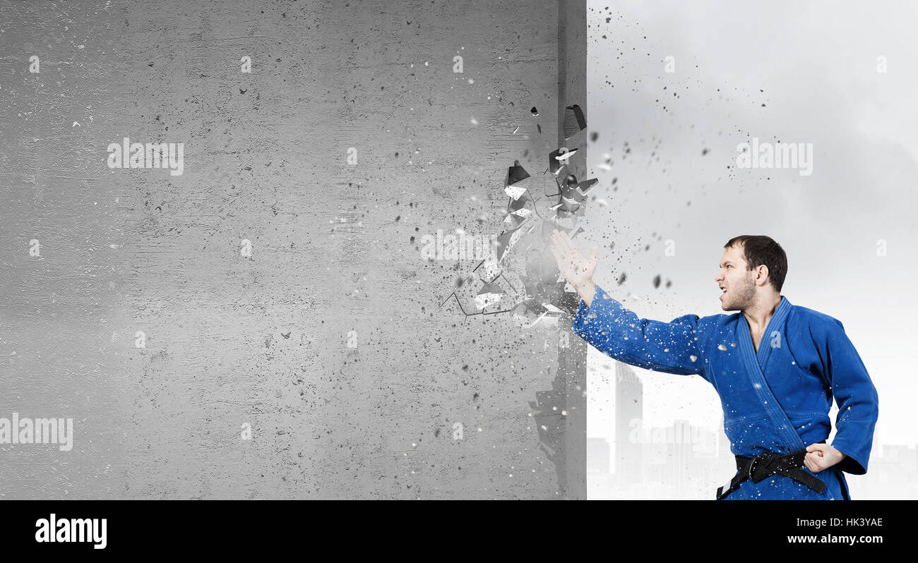 Young determined karate man breaking hi-res stock photography and ...