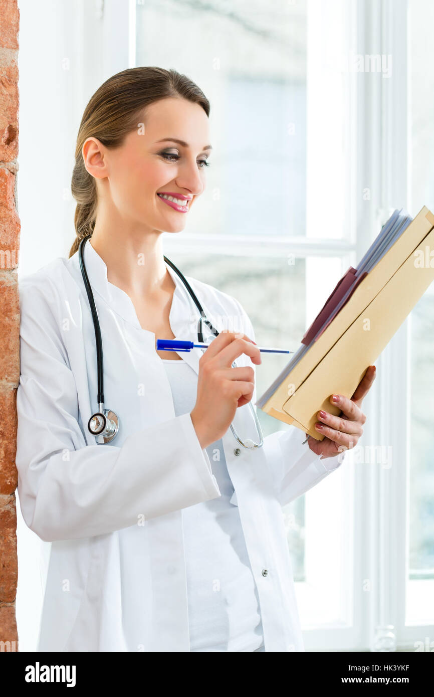 physicians in practice writing in medical record Stock Photo - Alamy