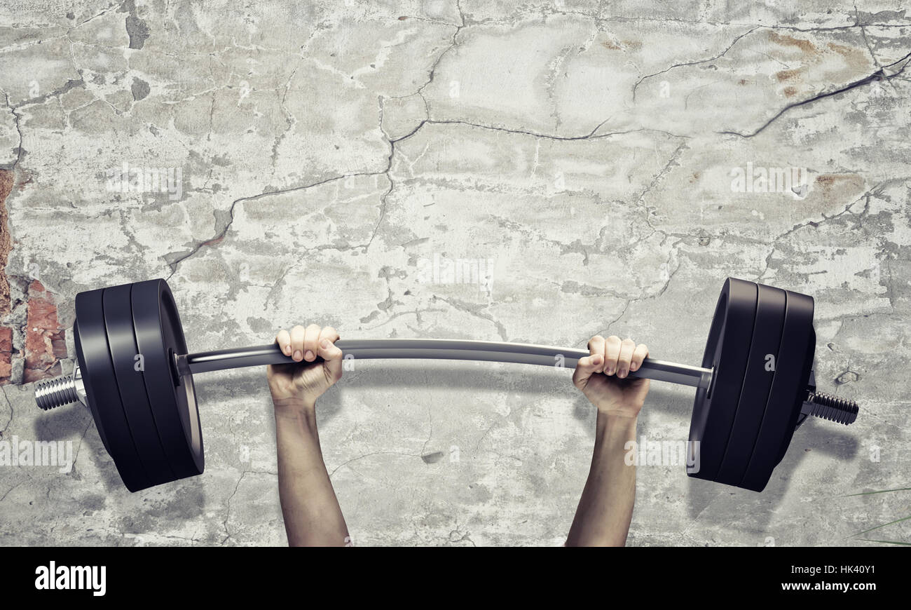 Lifting barbell above head. Strength and power Stock Photo - Alamy